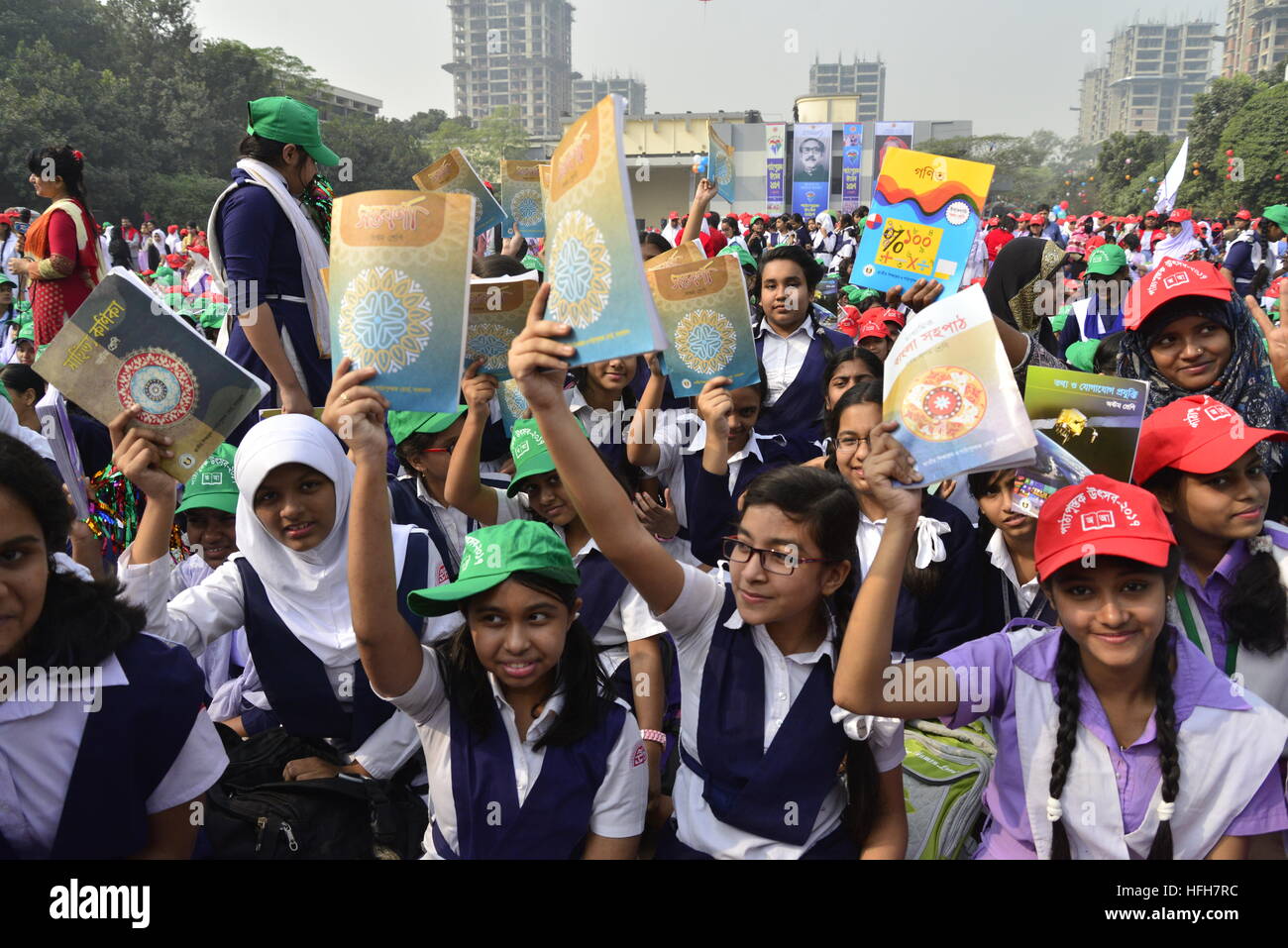 Bangladeshi School students rise up textbook during the Textbook ...