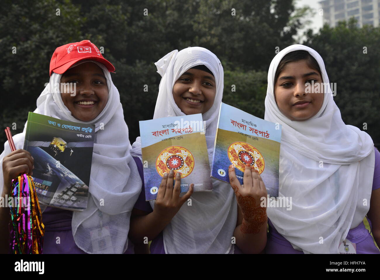 Bangladeshi School students rise up textbook during the Textbook ...