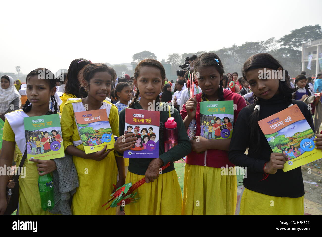 Bangladeshi School students rise up textbook during the Textbook ...