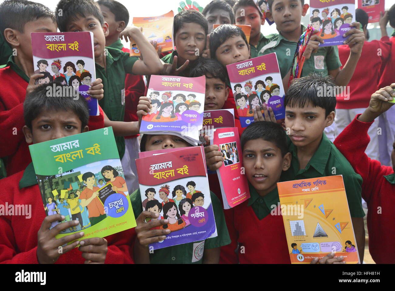 Bangladeshi School students rise up textbook during the Textbook ...