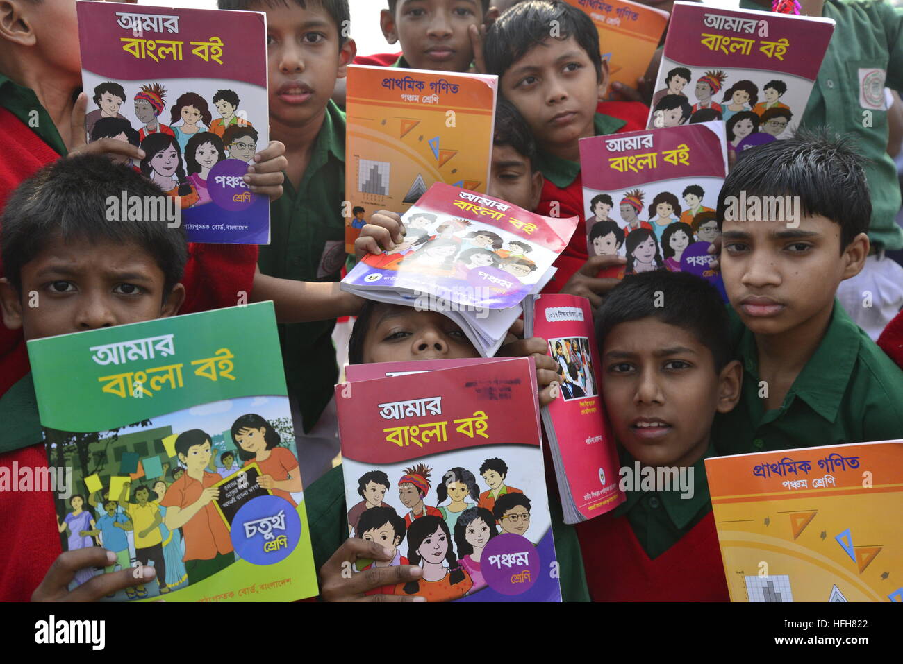 Bangladeshi School students rise up textbook during the Textbook ...
