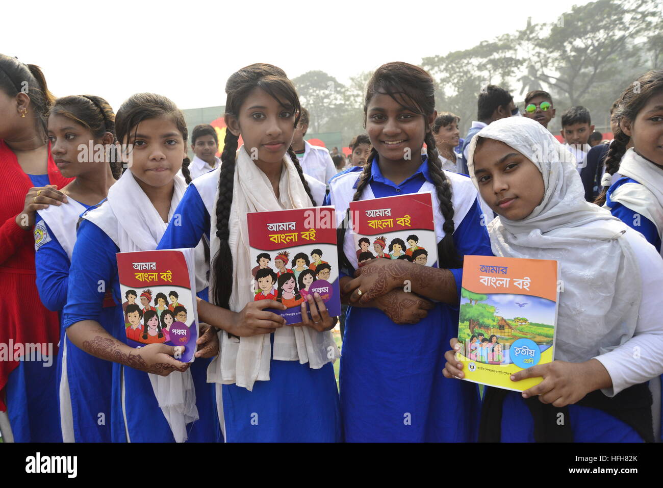 Bangladeshi School students rise up textbook during the Textbook ...
