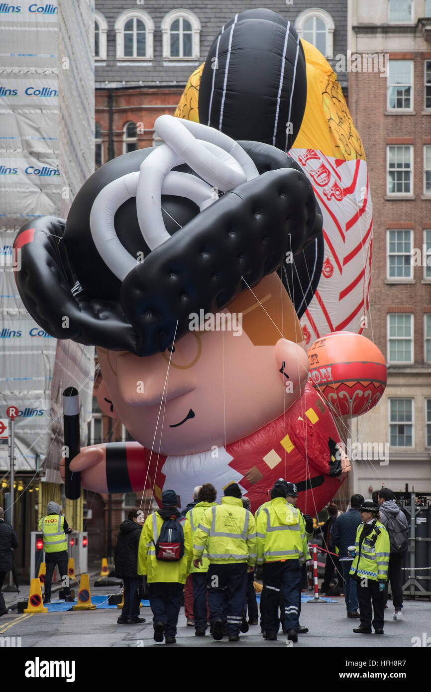 London, UK. 1st Jan, 2017. An inflatable town cryer waits in a side ...