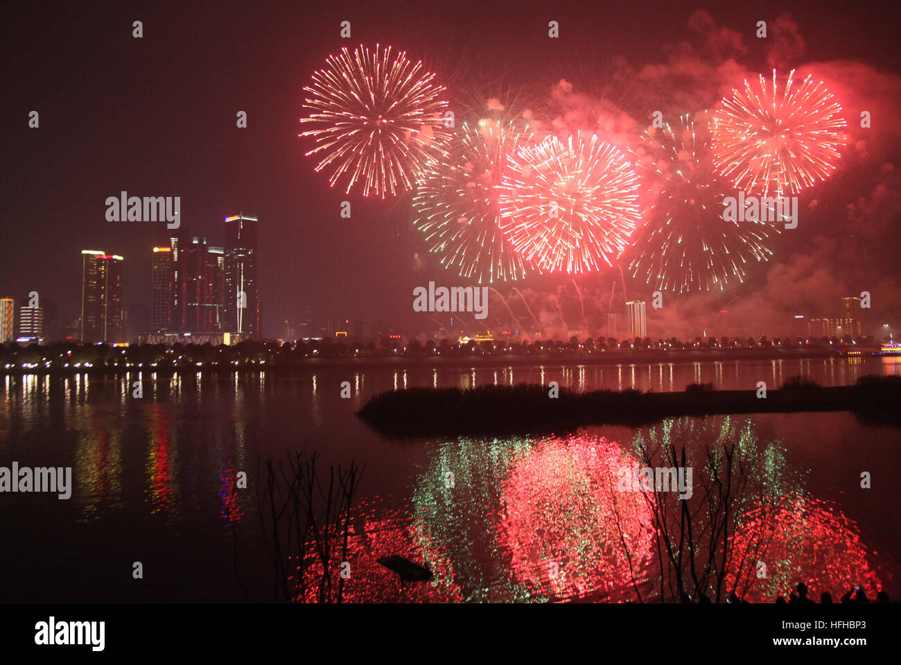 Changsha, China's Hunan Province. 1st Jan, 2017. Fireworks paint the ...