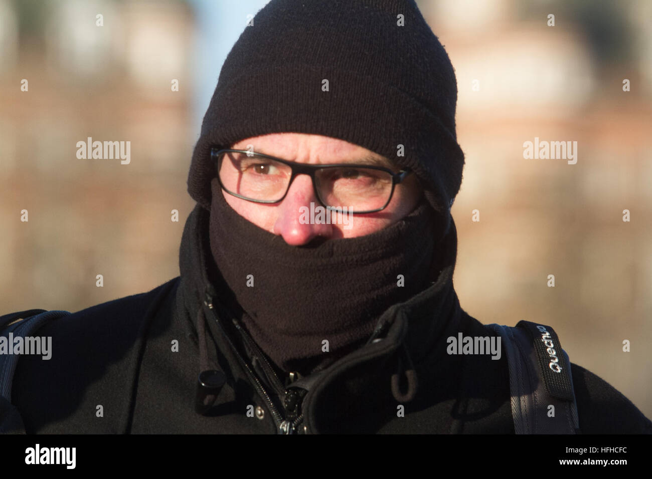 London, UK. 2nd Jan, 2017. A pedestrian wearing a balaclava on ...