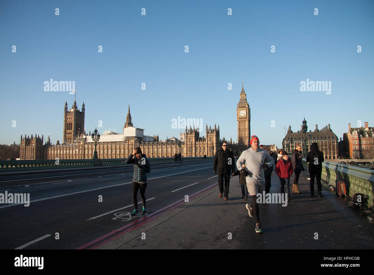 London, UK. 2nd Jan, 2017. Pedestrians on Westminster bridge wrap up ...