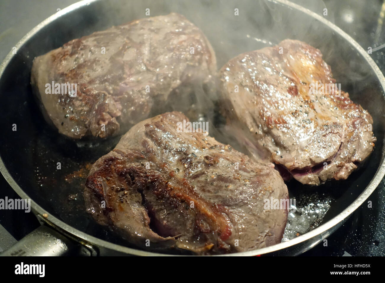 Three pieces of deer fillet frying in a pan, as seen on 24 December ...