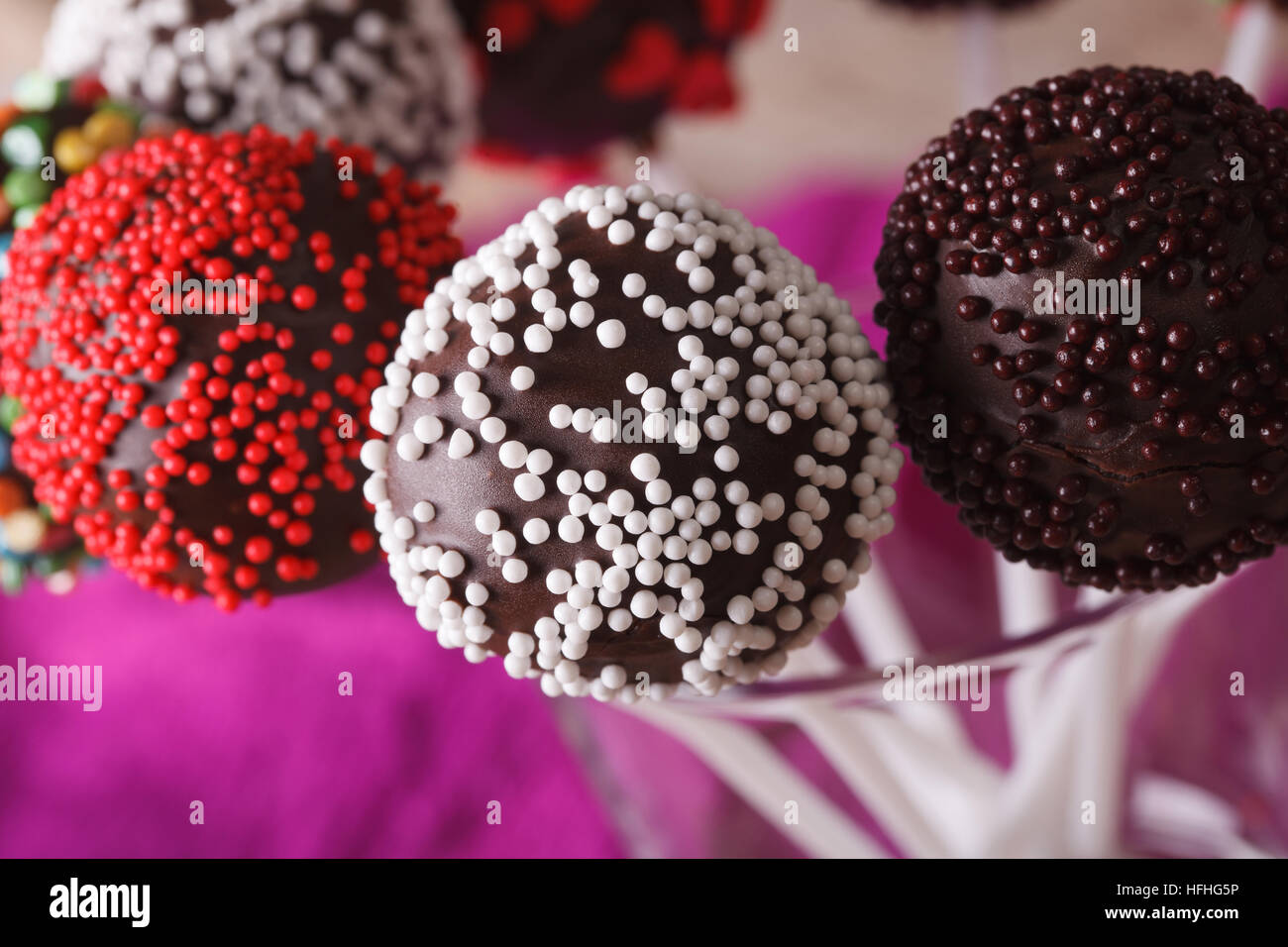 Beautiful chocolate cake pops with colorful candy sprinkles macro in ...