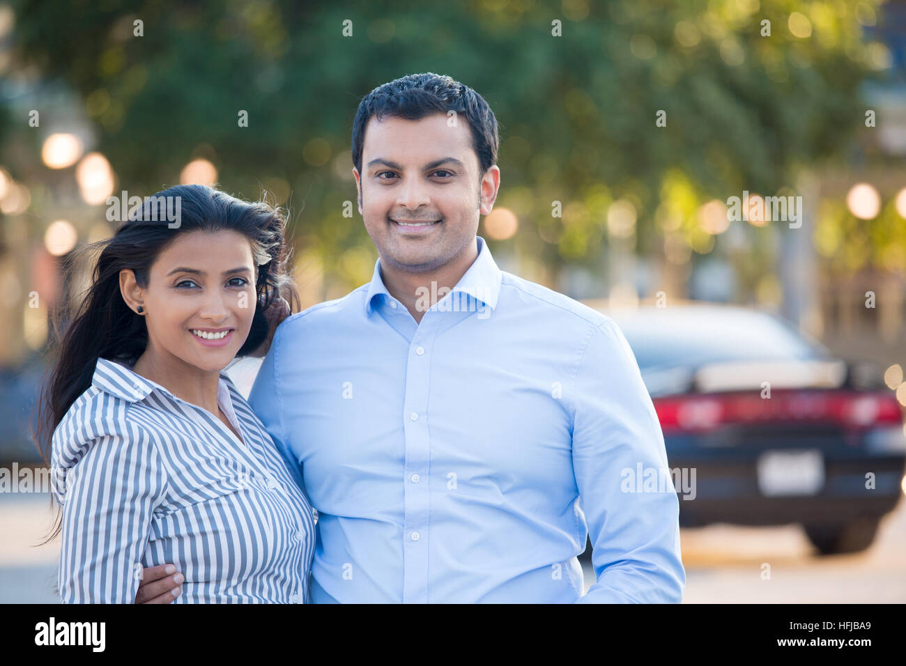 Closeup portrait, attractive wealthy successful couple in blue shirt ...
