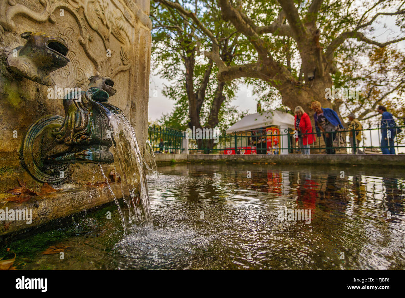 Old traditional fountain in the main square at the picturesque village ...