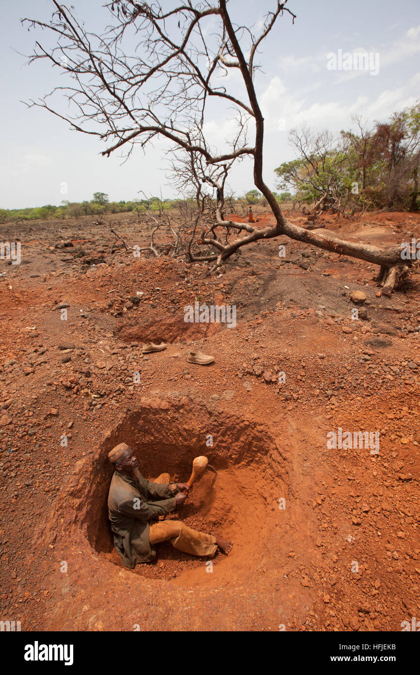 Sanana gold mine, Guinea, 2nd May 2015; An old miner digging a new plot ...