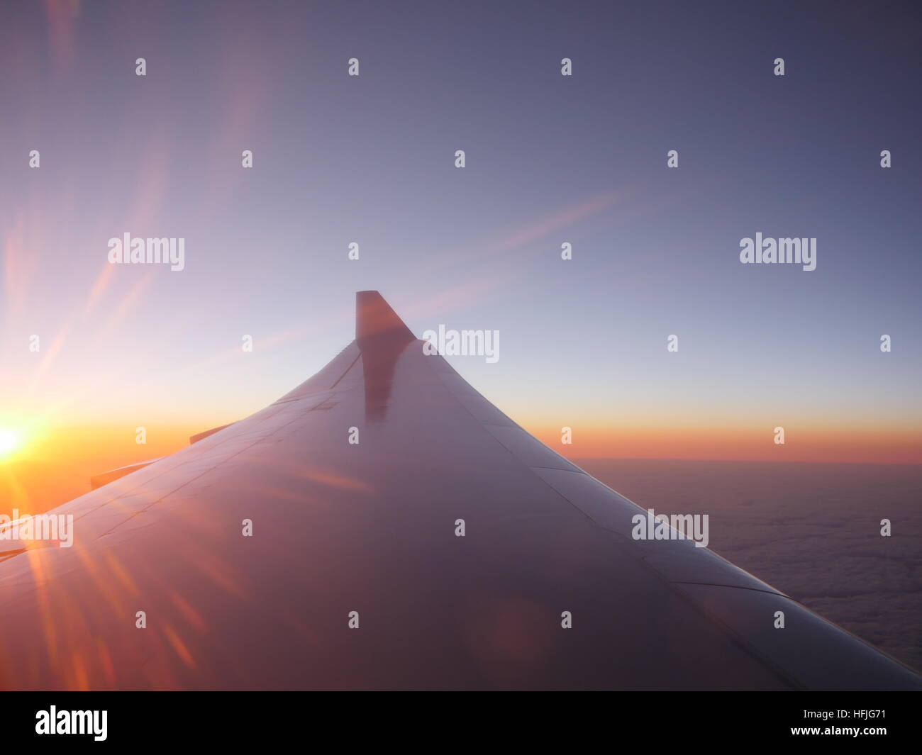 Flying airplane wing cloudy sunset hi-res stock photography and images ...