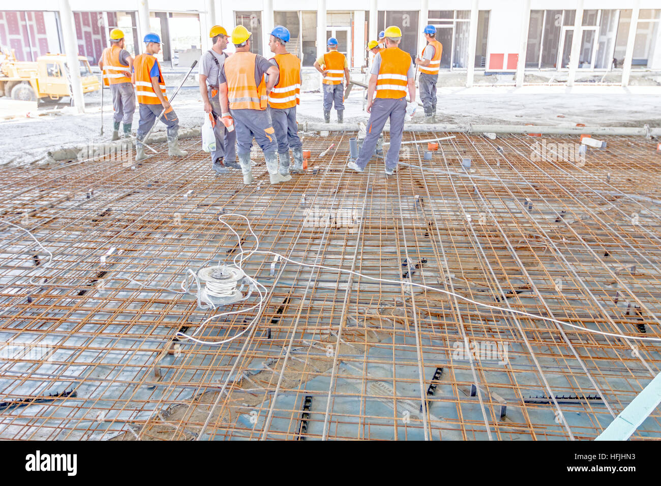 Break on building site, people are resting of spreading concrete over ...