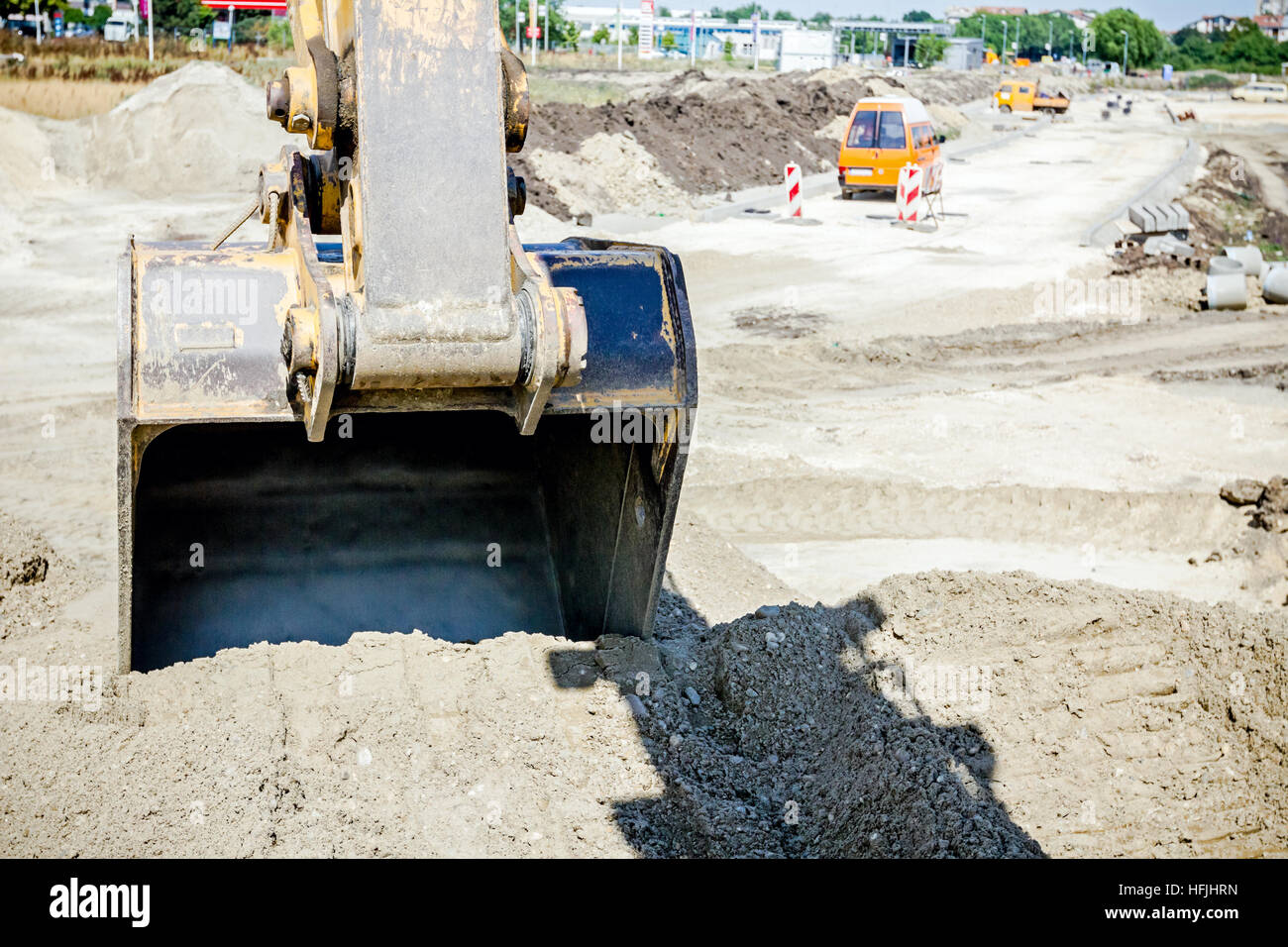 Excavator is digging with his bucket view from inside excavator's cabin ...