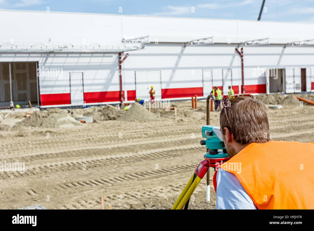 Surveyor engineer is measuring level on construction site. Surveyors ...