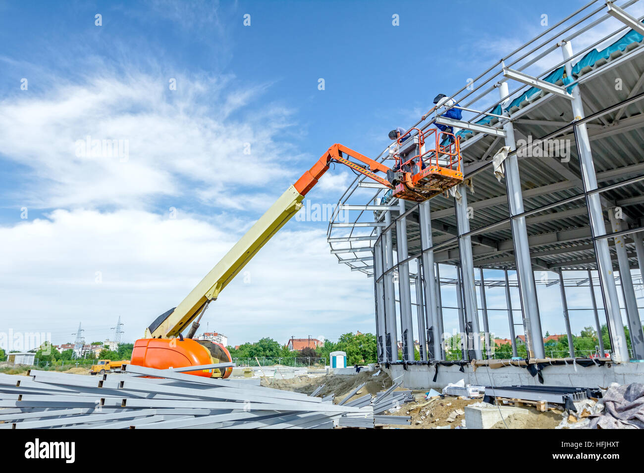 High elevated cherry picker people are working at new assembled ...