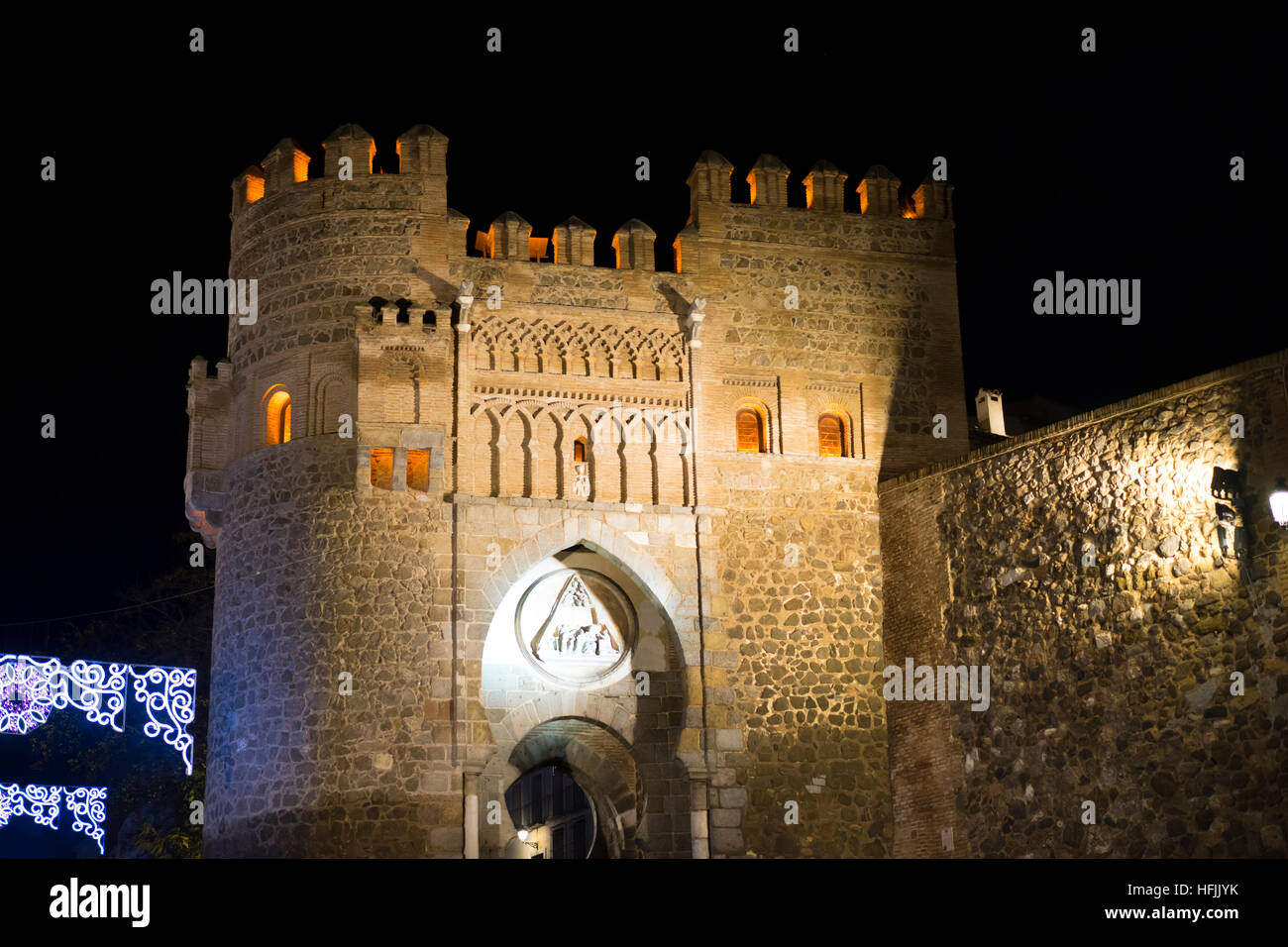 Wall with Toledo gate at night, beautiful building with big doors and ...