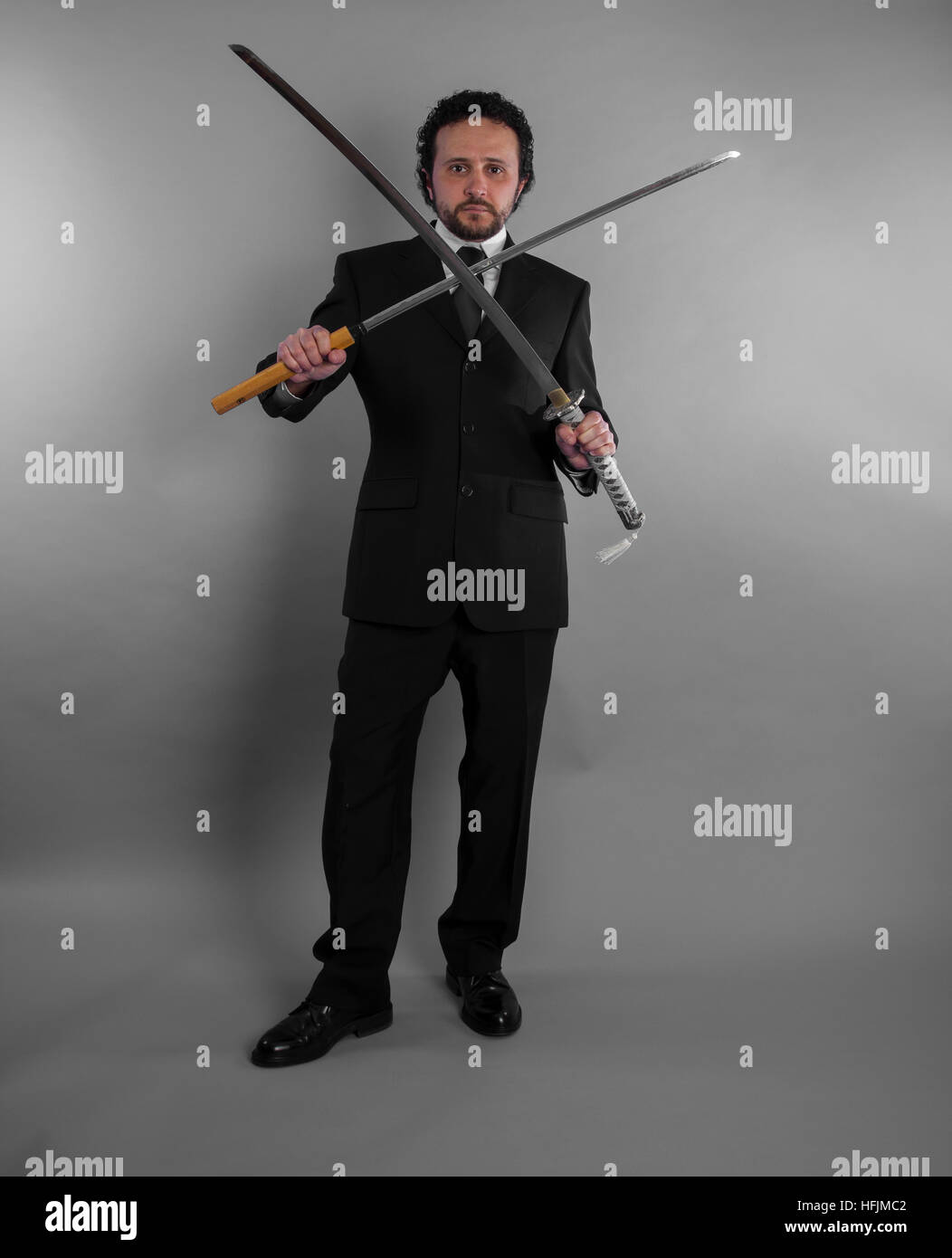 Aggressive businessman with Japanese swords in defensive and defensive ...