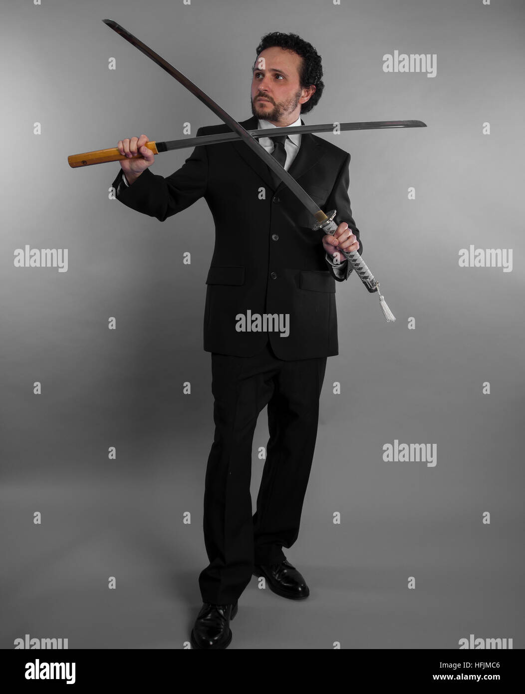 Aggressive businessman with Japanese swords in defensive and defensive ...