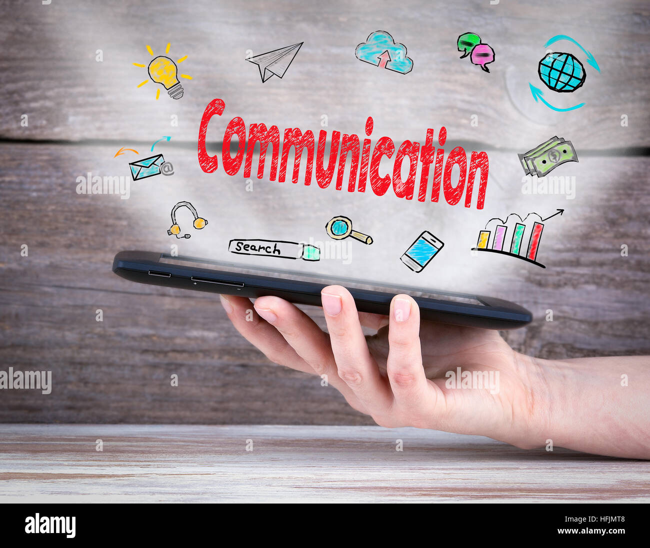 Communication concept. Tablet computer in the hand. Old wooden ...