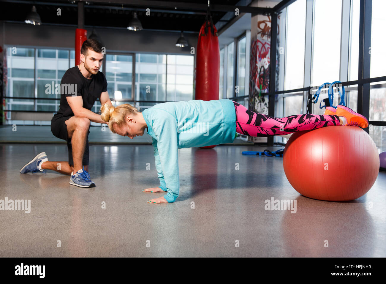 Training young woman with coach Stock Photo - Alamy