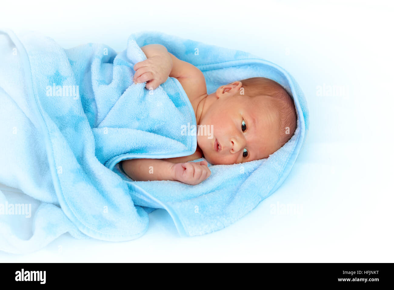 One week old baby in blanket on white background Stock Photo - Alamy