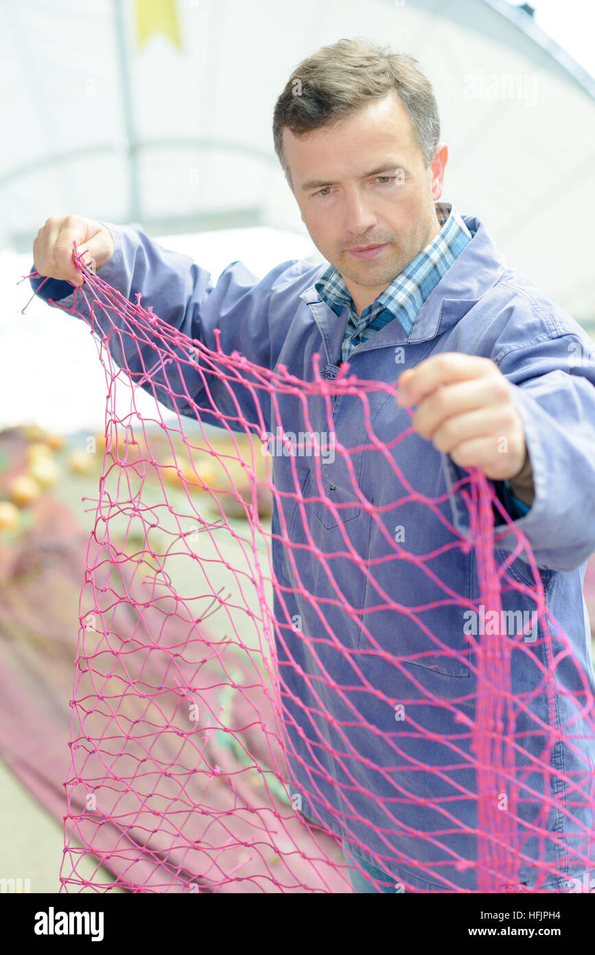 fisherman checking the net Stock Photo - Alamy