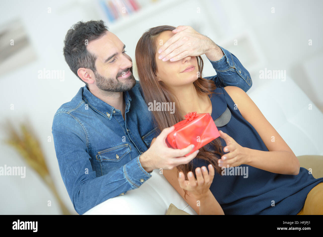 young attentive man offering gift to his beloved girlfriend Stock Photo ...