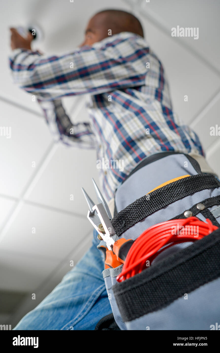 Electrician fitting light in ceiling Stock Photo - Alamy
