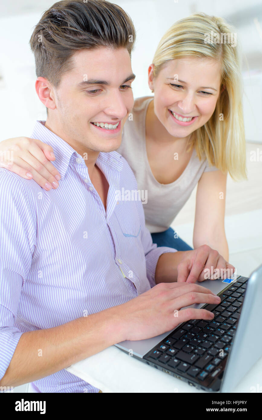 Couple using a laptop Stock Photo - Alamy