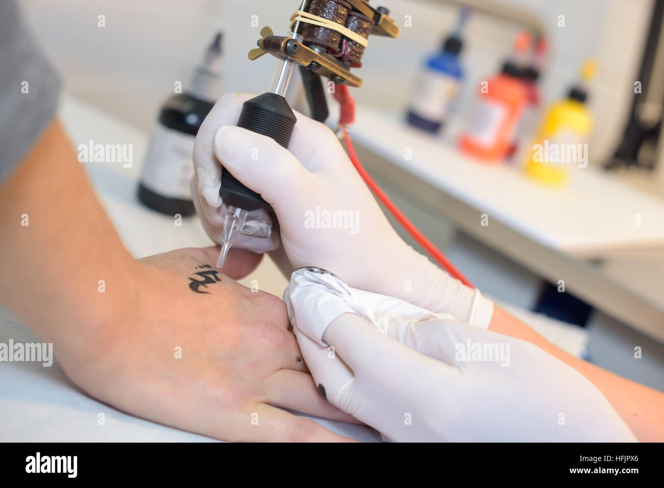 getting a tattoo Stock Photo - Alamy