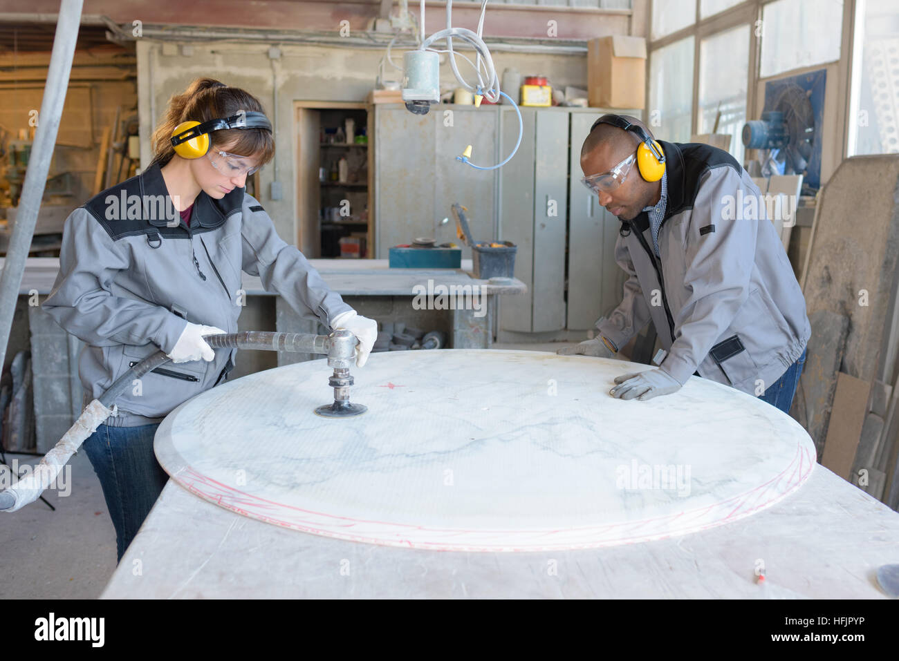 Workers sanding round piece of marble Stock Photo - Alamy