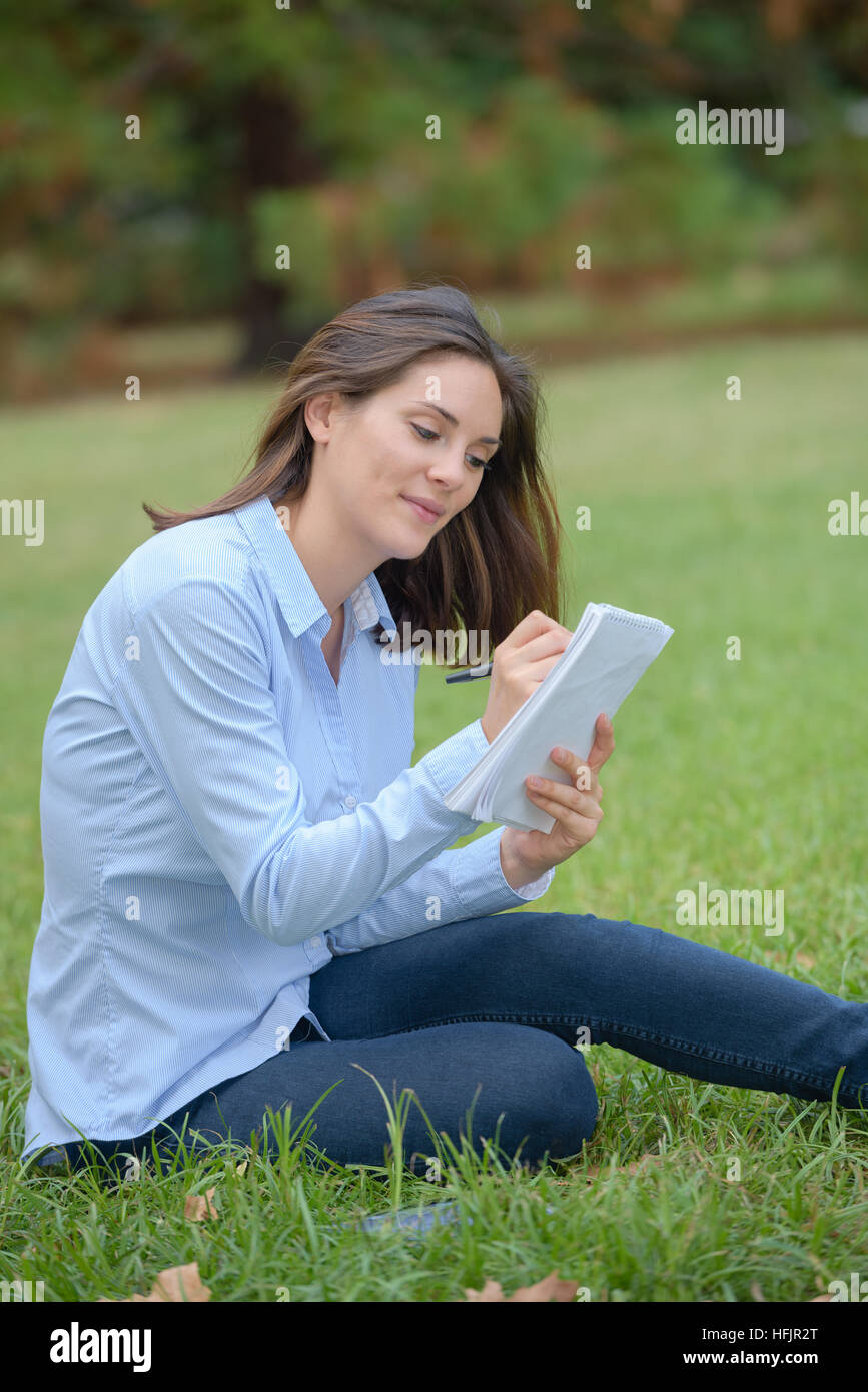 woman happily writing letters in park Stock Photo - Alamy
