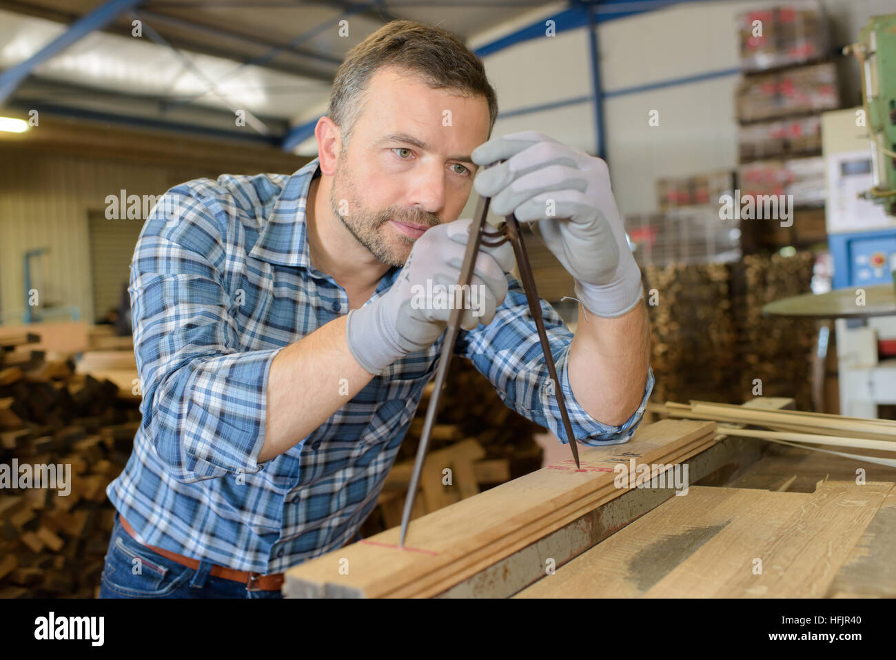 Carpenter setting angle on compass Stock Photo - Alamy