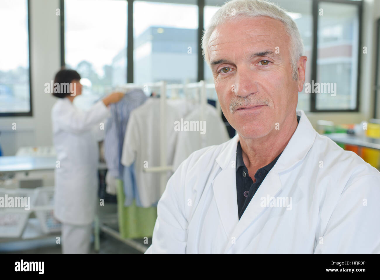 Closeup of man in professional laundry Stock Photo - Alamy