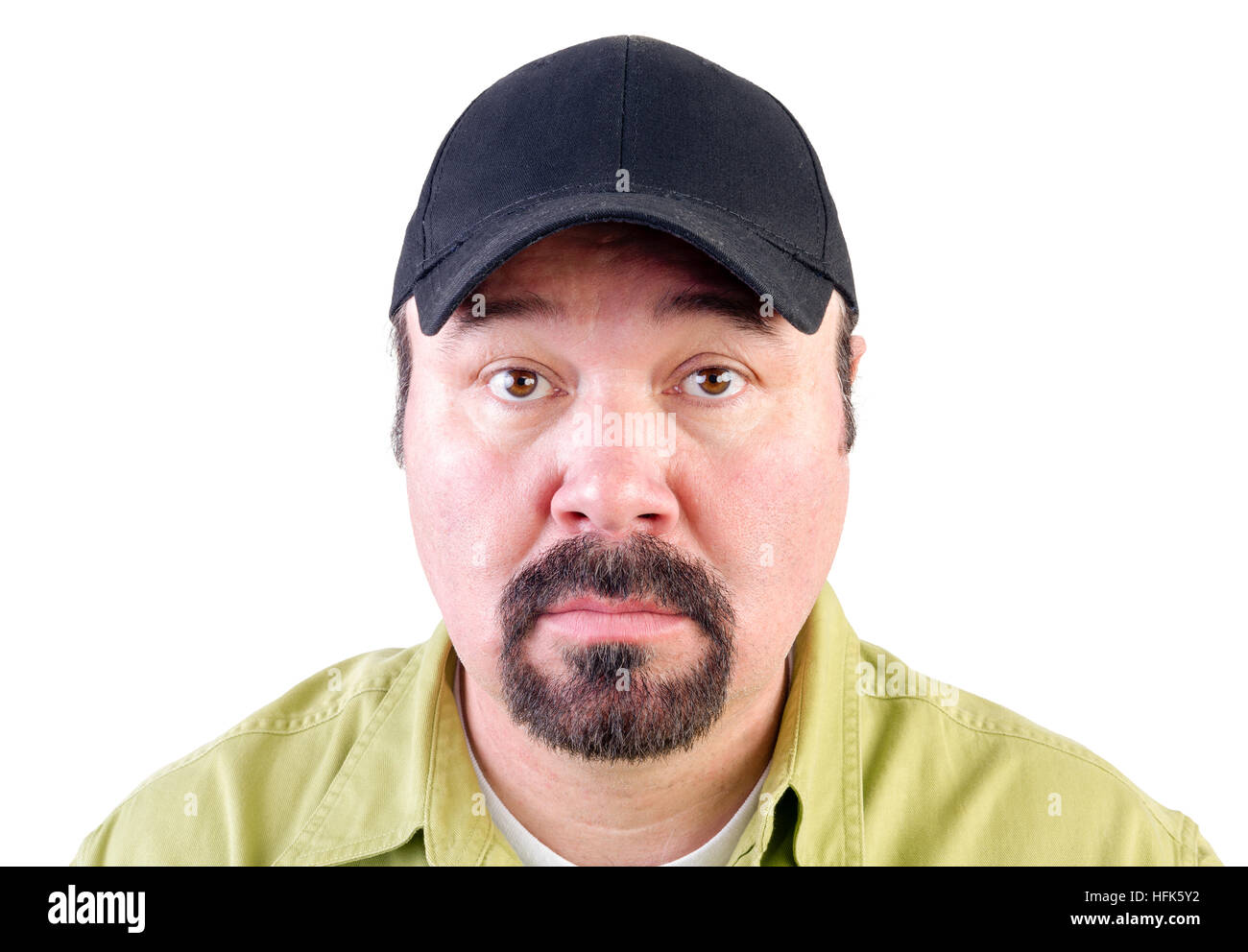 Portrait of staring man with goatee wearing baseball cap, white ...