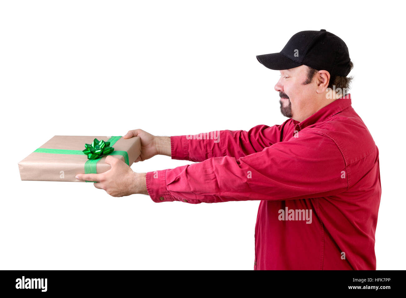 Side half body portrait of man in baseball cap giving wrapped present ...