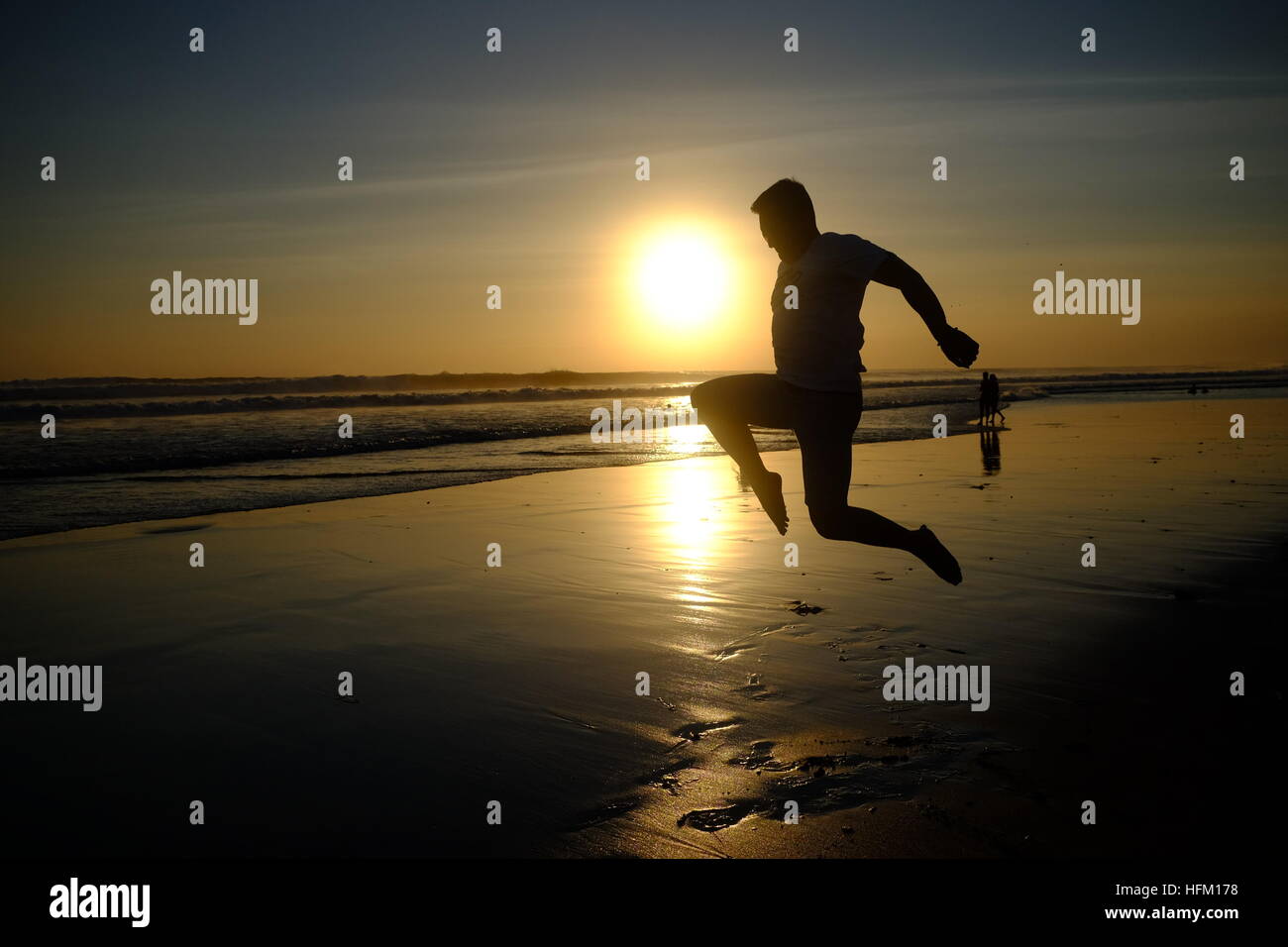 Kicking the sun Stock Photo - Alamy