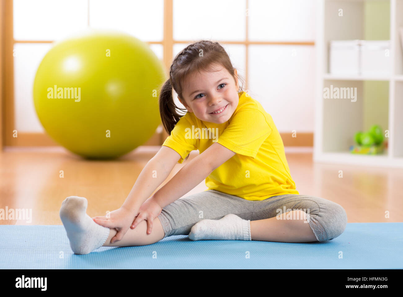 Preschooler child girl doing fitness exercises Stock Photo - Alamy