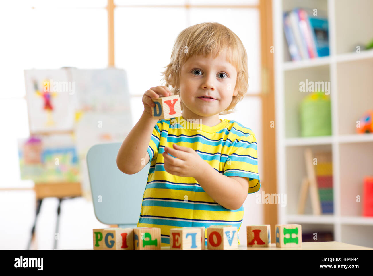 Little preschooler kid boy playing with toy cubes and memorizing ...