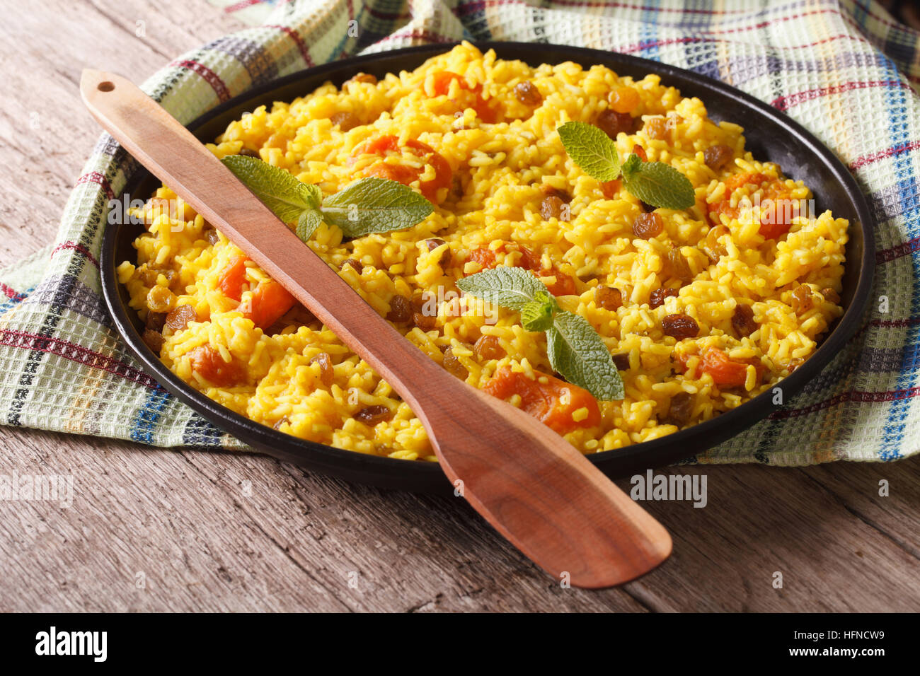 Delicious sweet rice with saffron and dried fruits close-up on the ...