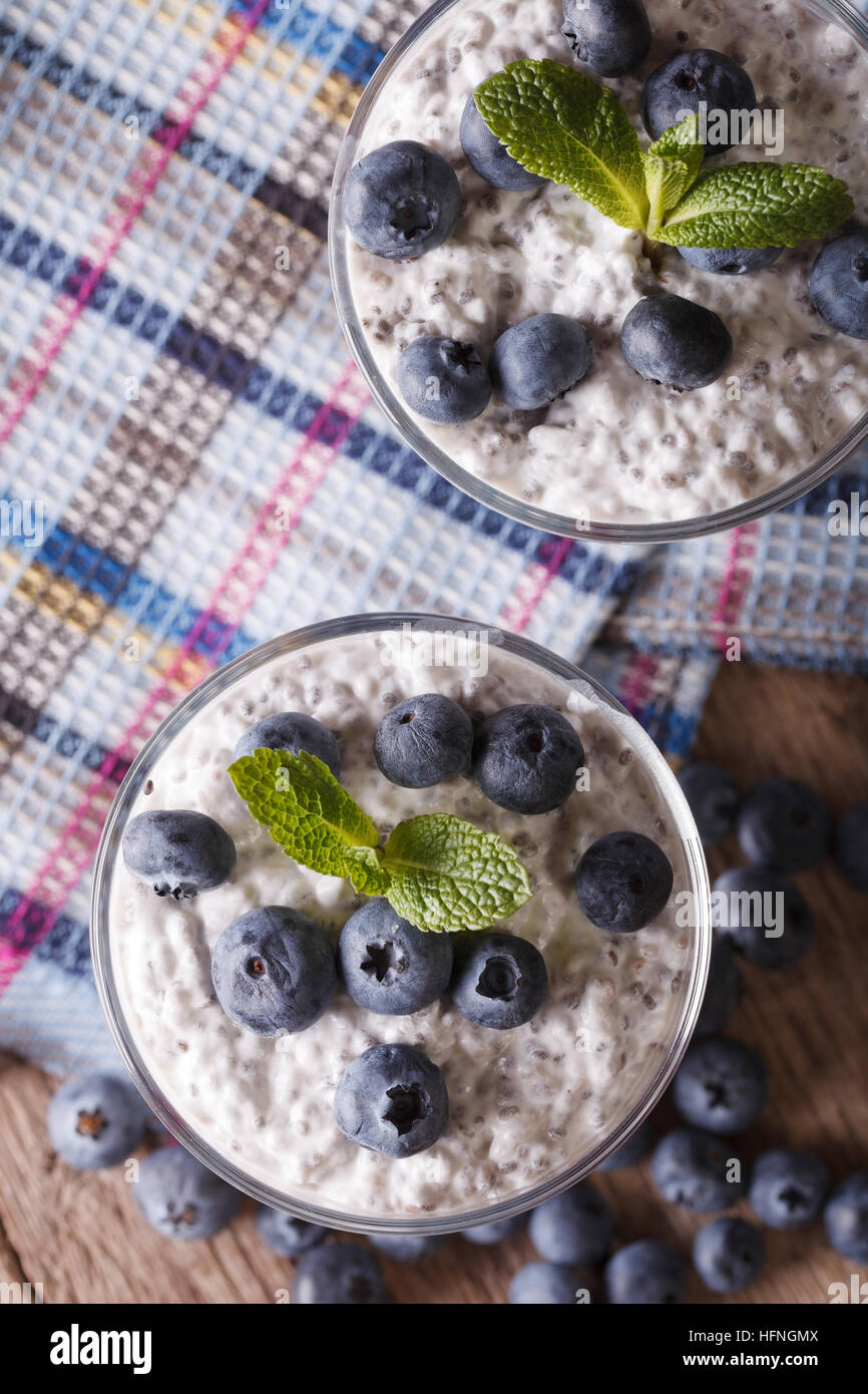 Chia seed pudding and blueberry close-up on the table. vertical top ...