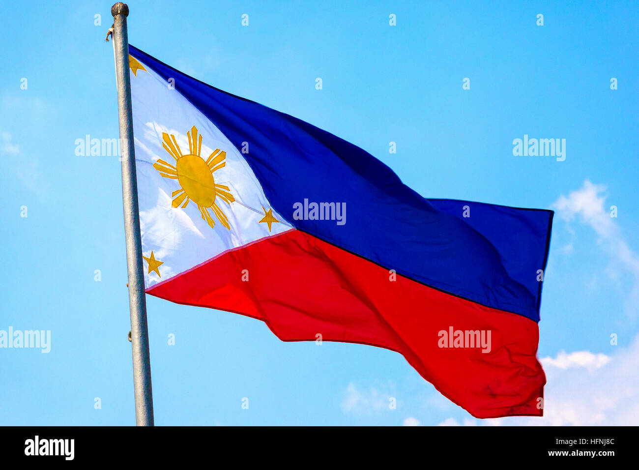 Philippine National flag flying in the breeze Stock Photo - Alamy