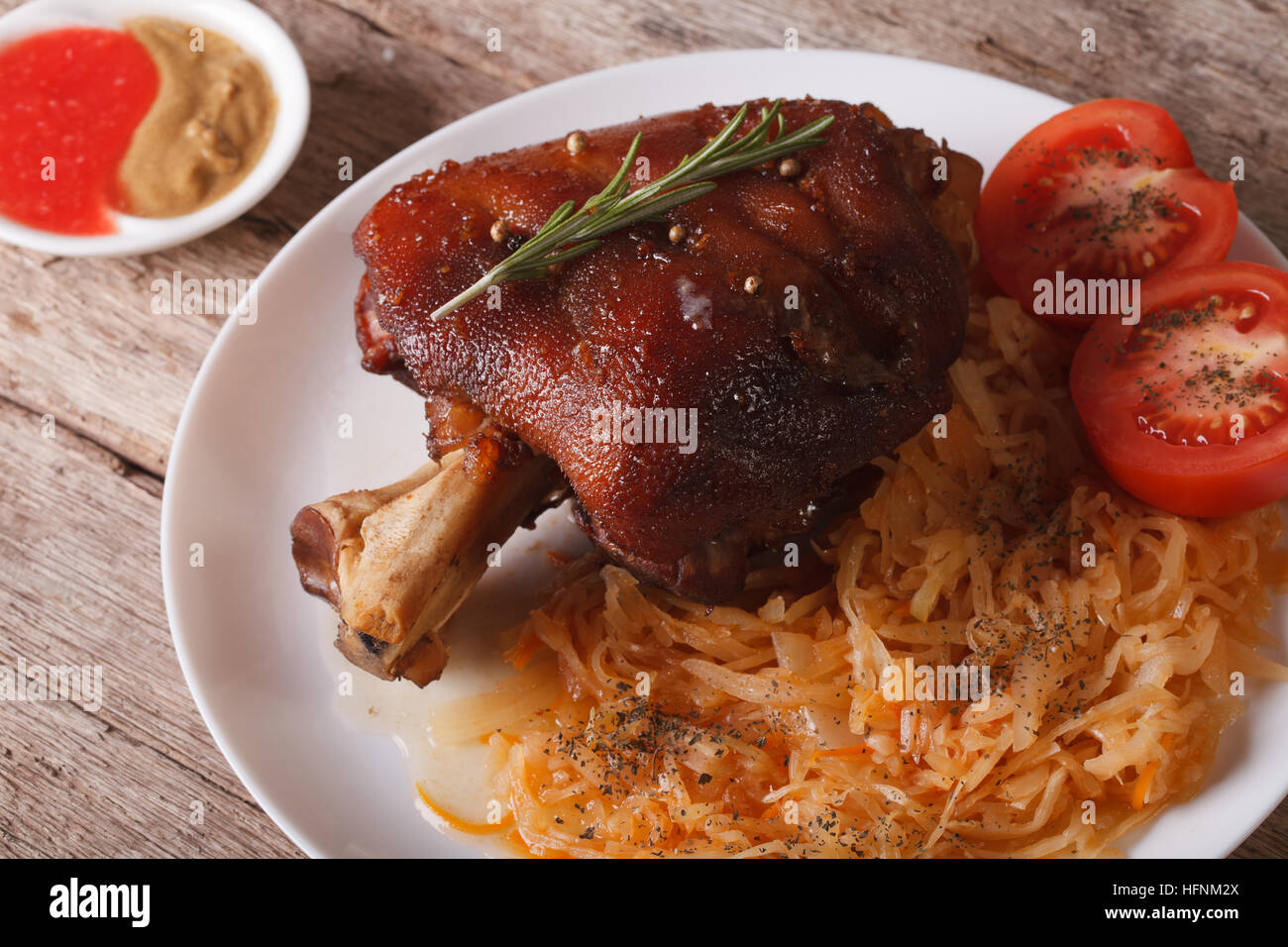 European cuisine: Baked pork knuckle and sauerkraut closeup on a plate ...