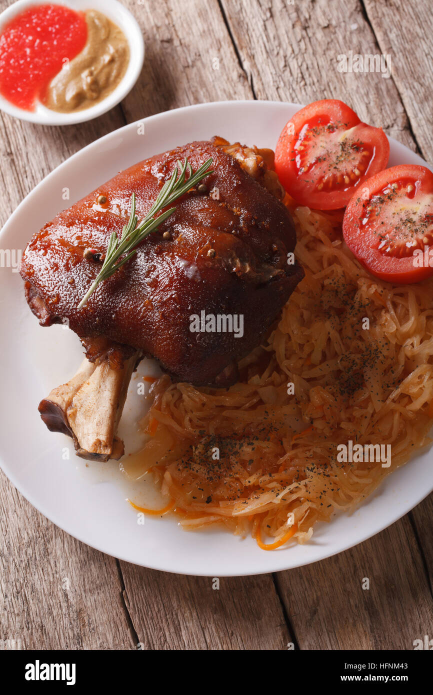 European cuisine: Baked pork knuckle and sauerkraut closeup on a plate ...