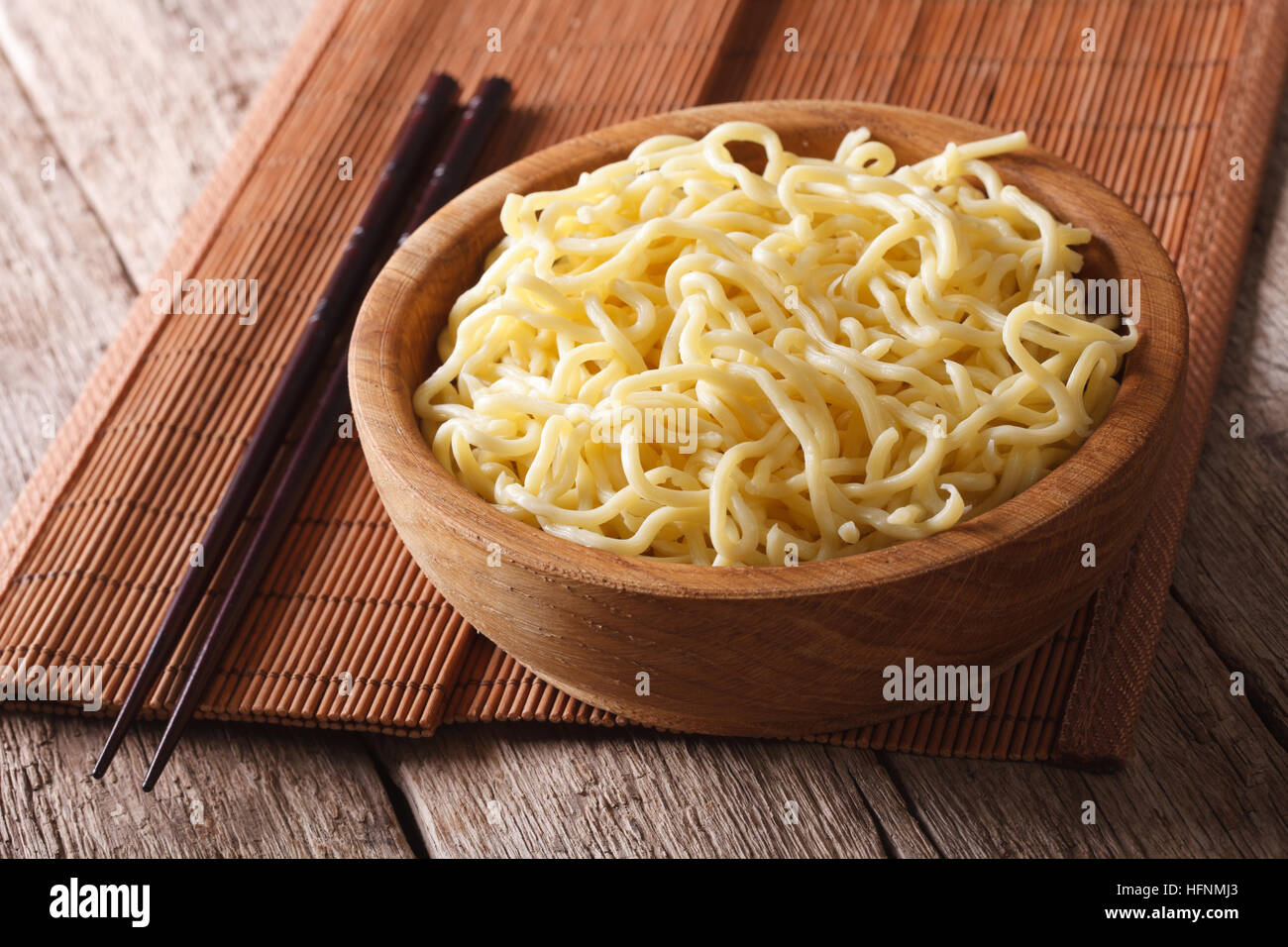 Asian ramen noodles in wooden bowl close-up on the table. horizontal ...