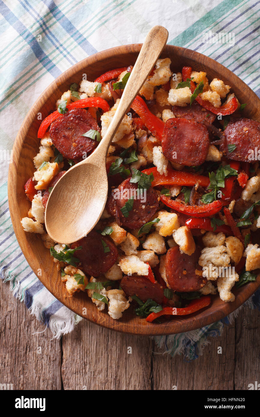 Spanish migas with chorizo, bread crumbs and vegetables close-up on a ...