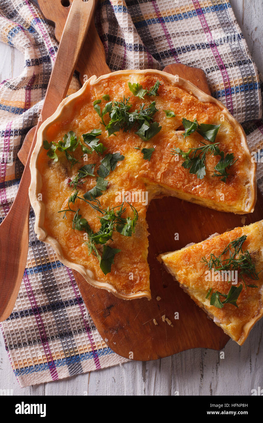 French quiche Lorraine close-up on a cutting board. vertical top view ...