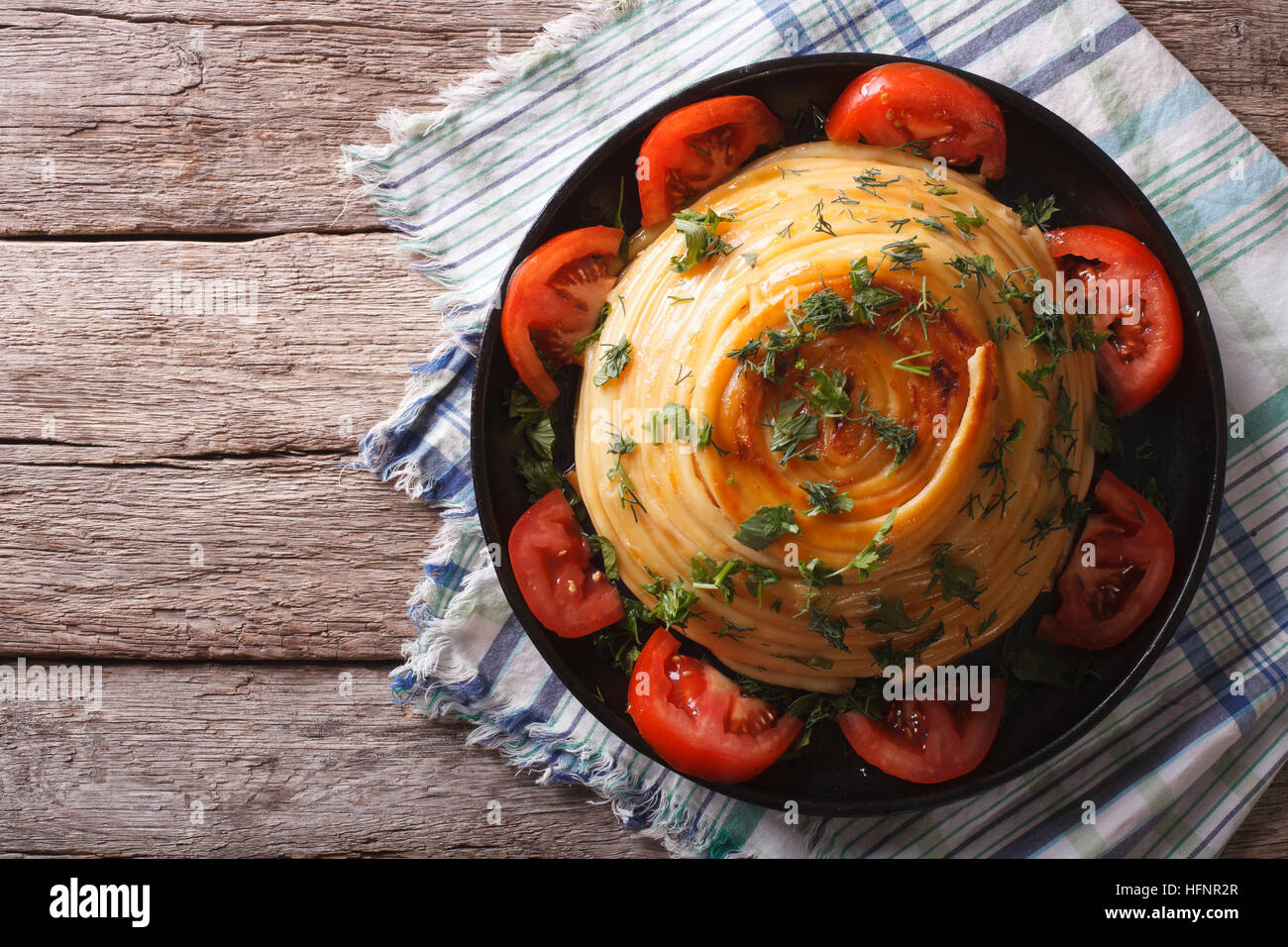 French timbale of pasta with cheese and vegetables on a plate ...