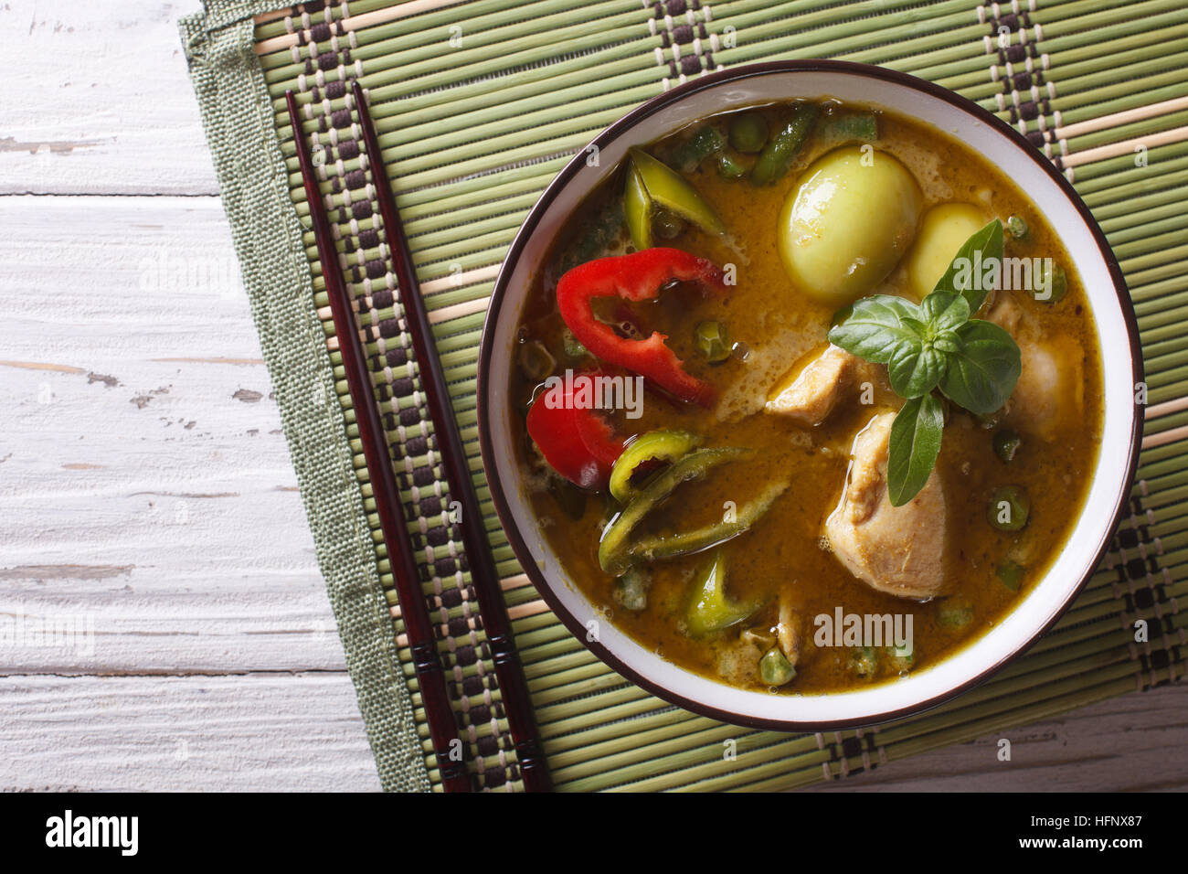 Thai cuisine: green curry chicken close-up on the table. horizontal ...
